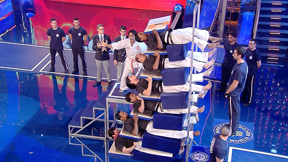 Daring martial arts experts create the most layers in a bed of nails ...