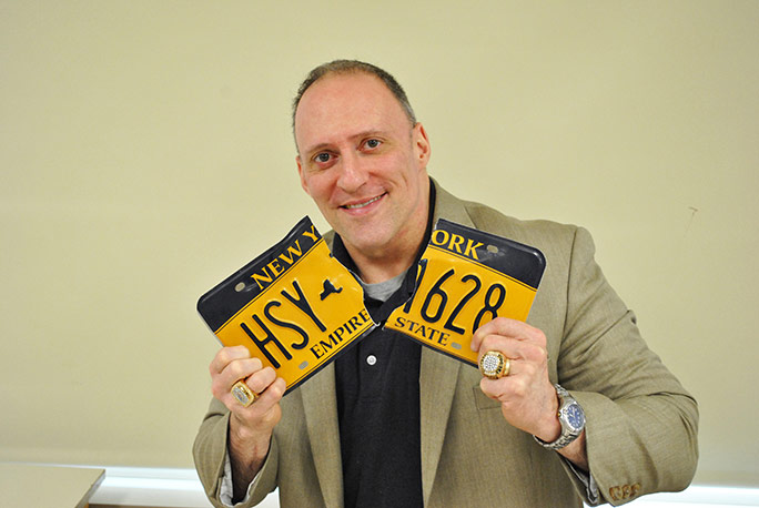 Professional strongman tears vehicle license plates in half to earn new ...