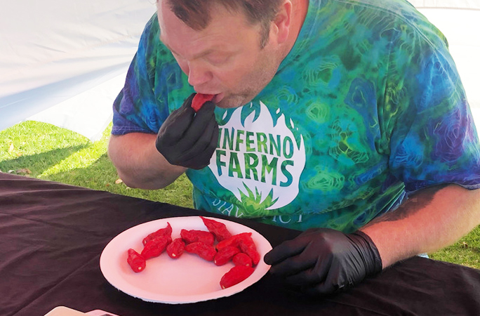 Man speed-eats Ghost chilli peppers in a minute to break record ...