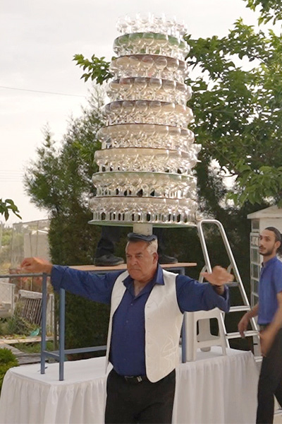 Cypriot man shatters record with 319 wine glasses balanced on head ...