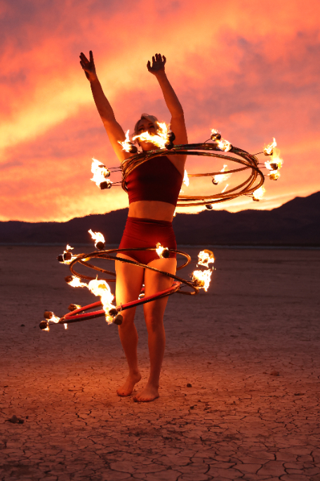Fire performer fights through 'fire kiss' burns to spin eight flaming ...
