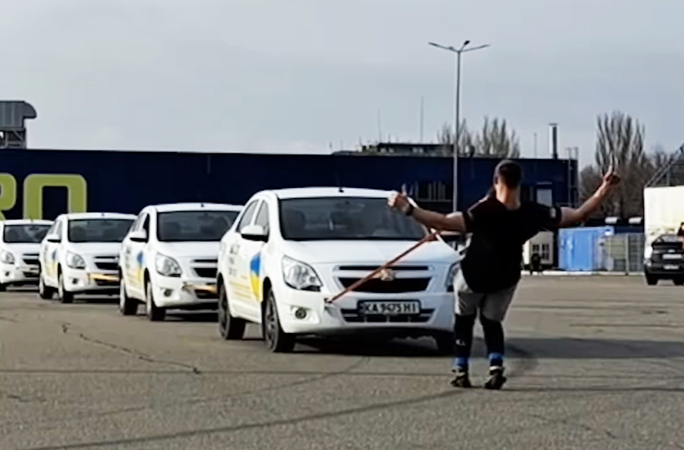 Ukrainian man pulls six cars with his teeth to break record | Guinness ...