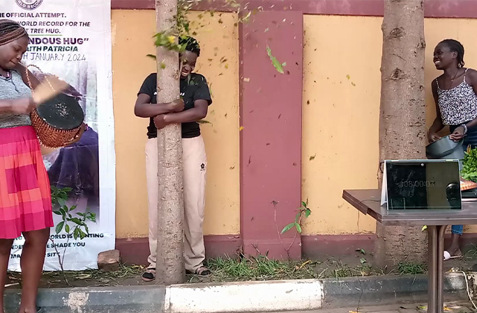 Ugandan activist hugs tree for 16 hours to set world record: "The tree ...