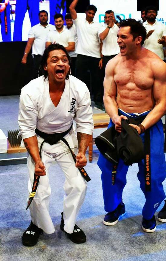 Martial arts pros form 8-layer bed of nails sandwich in record-breaking ...