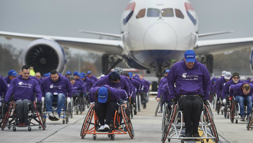 Record-breaking wheelchair team pulls plane at Heathrow to help ...
