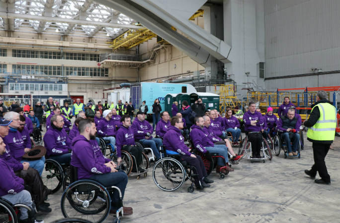 Record-breaking wheelchair team pulls plane at Heathrow to help ...