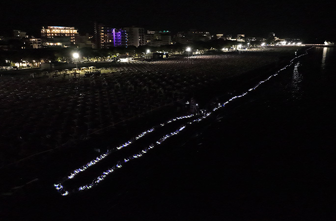Thousands light up sandy Italian beach to break world record | Guinness ...