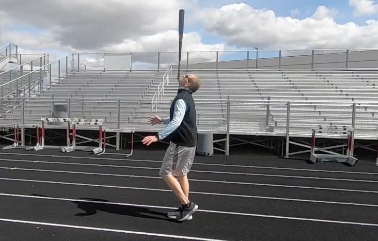 Farthest distance walked balancing a baseball bat on the chin ...