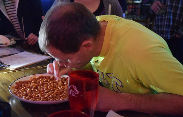 Most baked beans eaten in one minute with a cocktail stick | Guinness ...