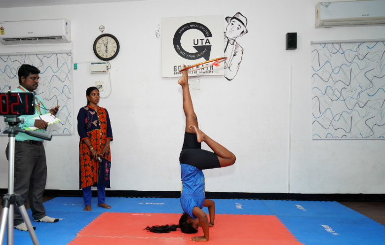 Most rotations of a hula hoop on one foot whilst in headstand position in one minute | Guinness ...