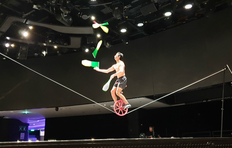 Most juggling catches on a unicycle while balancing on a slackwire ...