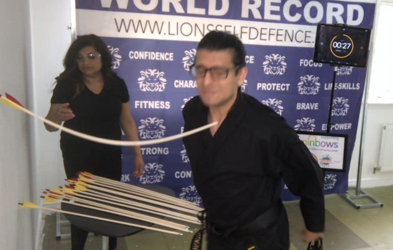 Most arrows broken with the neck in 30 seconds | Guinness World Records