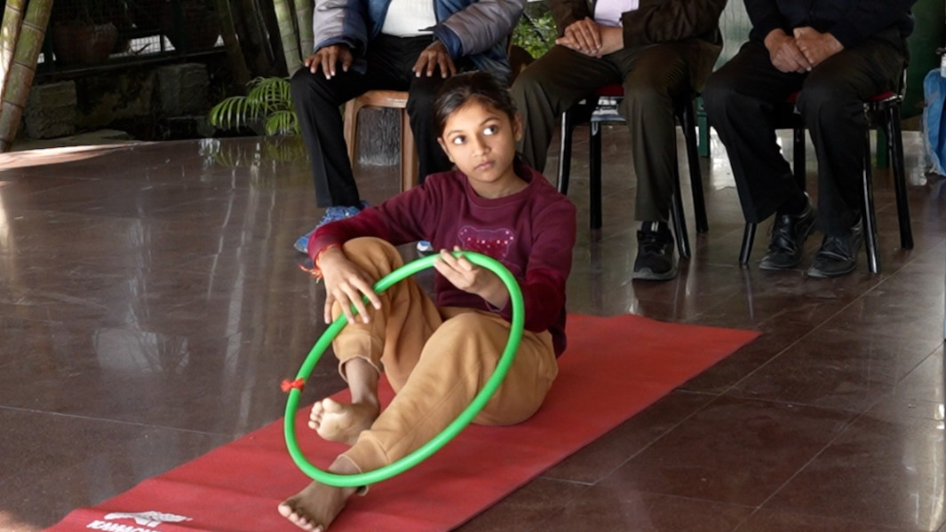 Most hula hoop rotations around the foot while lying down in 30 seconds ...