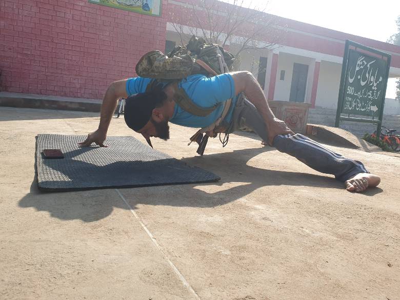 Most one arm finger tip push ups carrying a 60 lb pack in one minute ...