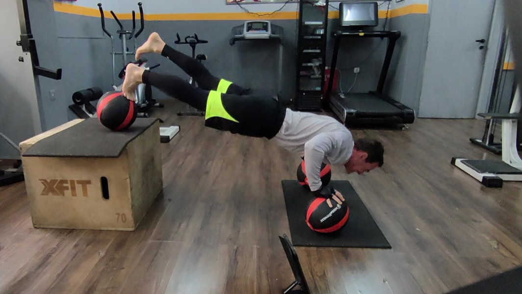 Most decline push ups (one leg raised) on medicine balls in one minute ...