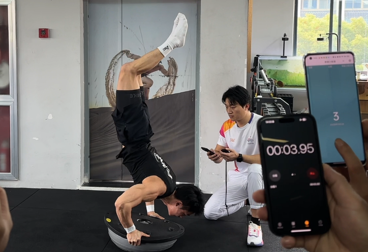 Most handstand push ups on a half balance ball in one minute (male ...
