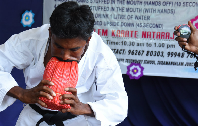 Most straws stuffed in the mouth (with hands) | Guinness World Records